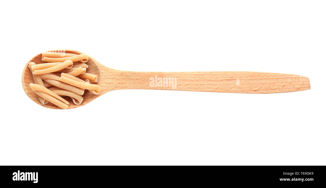 Wooden spoon with raw pasta on white background Stock Photo - Alamy