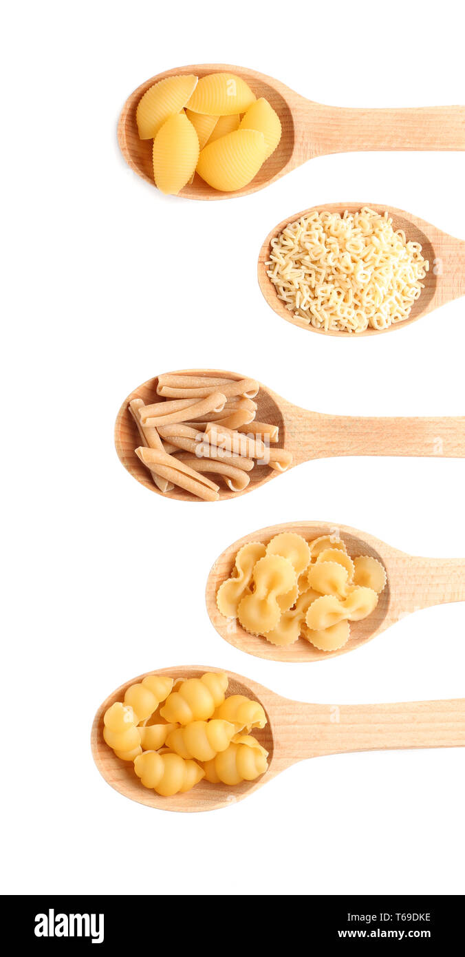 Wooden spoons with different types of pasta on white background Stock ...