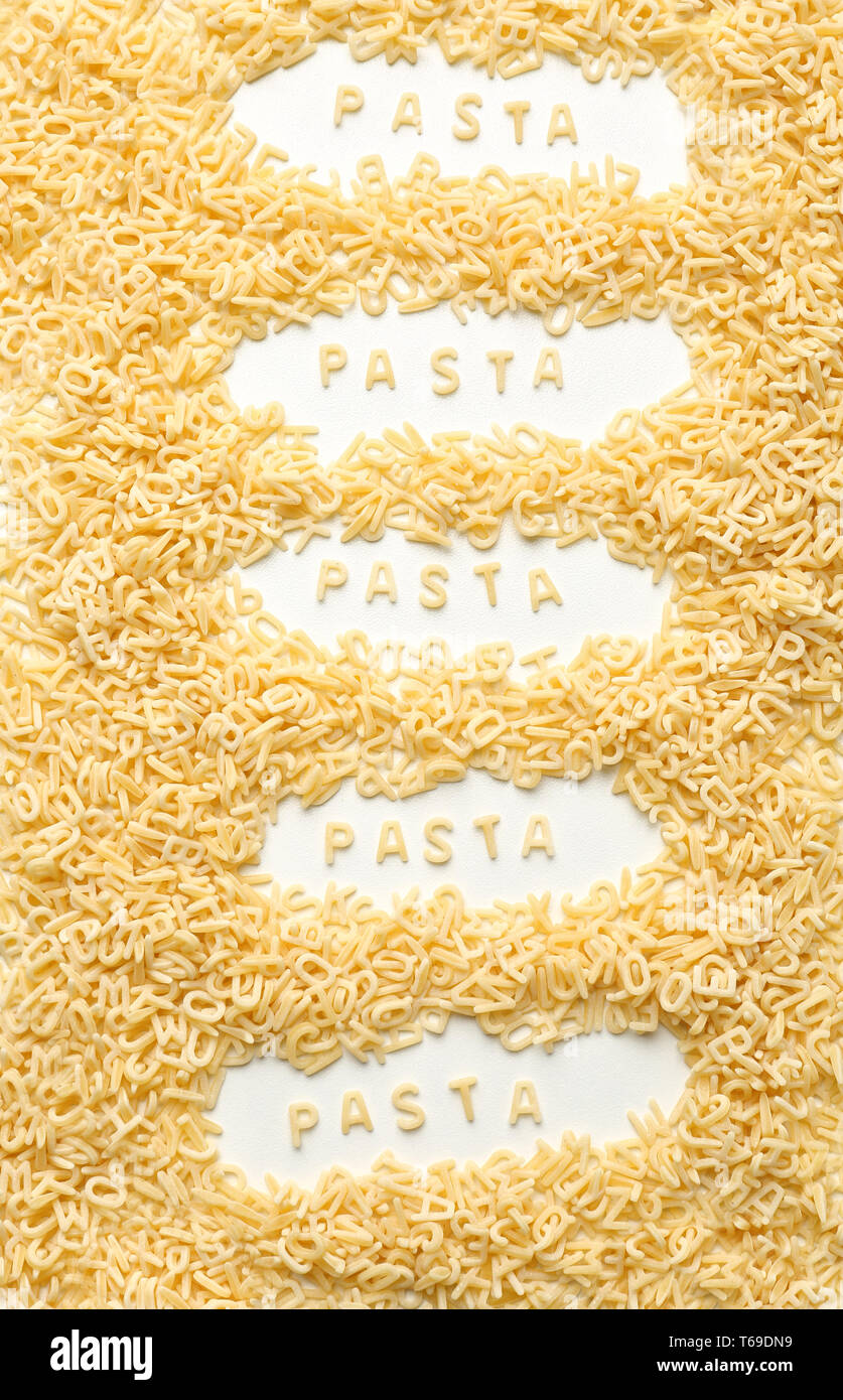 Composition with raw alphabet pasta on white background Stock Photo - Alamy