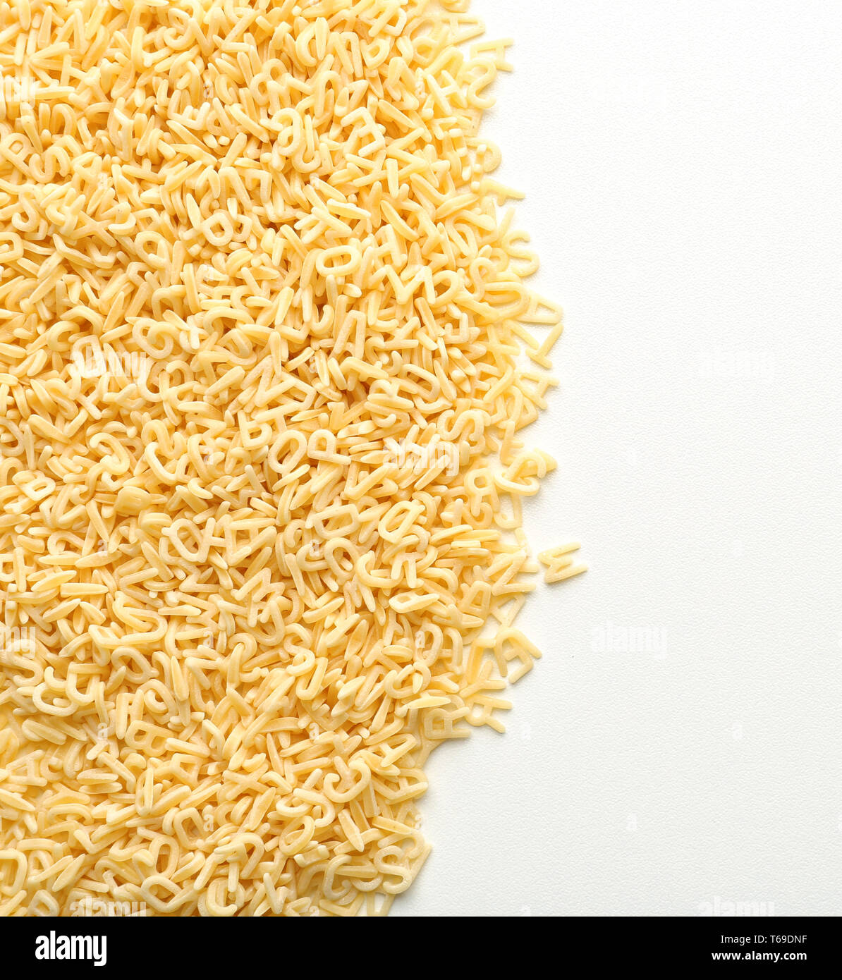 Raw alphabet pasta on white background Stock Photo - Alamy