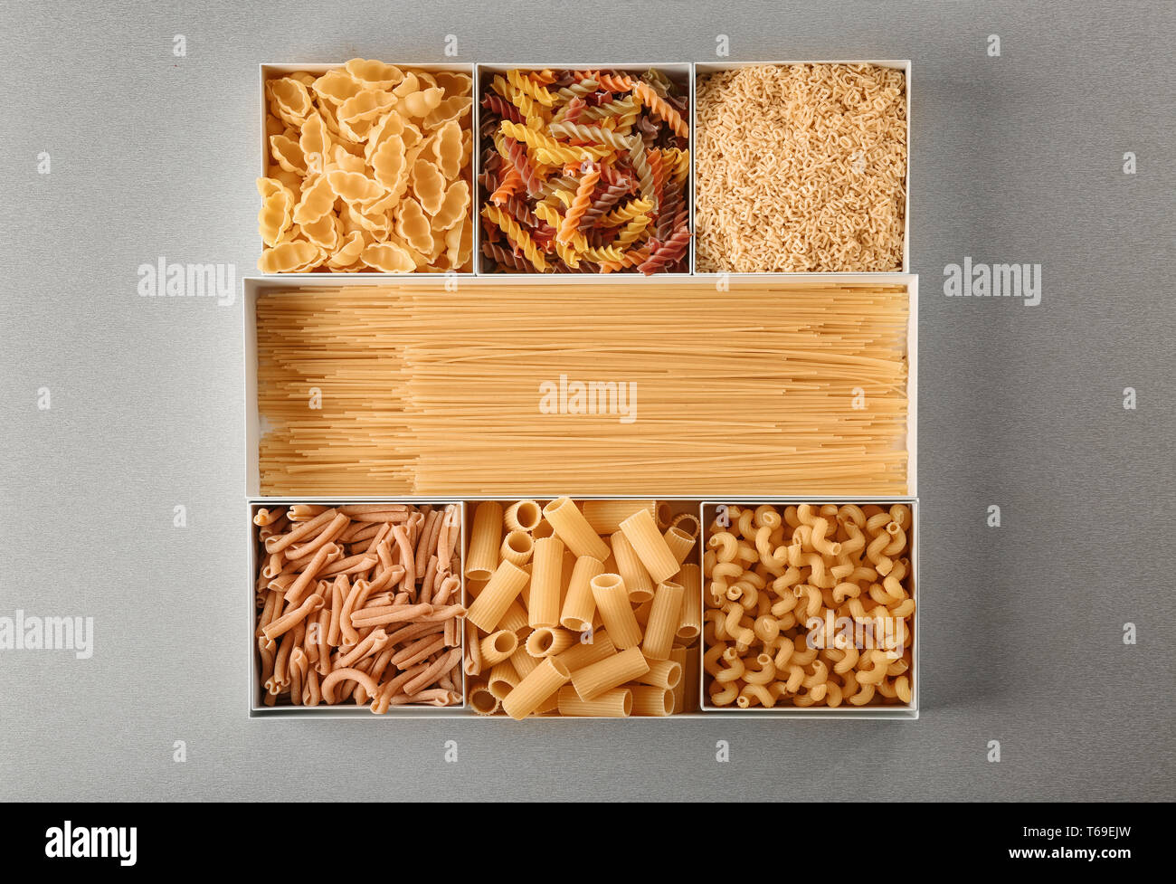 Boxes with different uncooked pasta on light background Stock Photo - Alamy