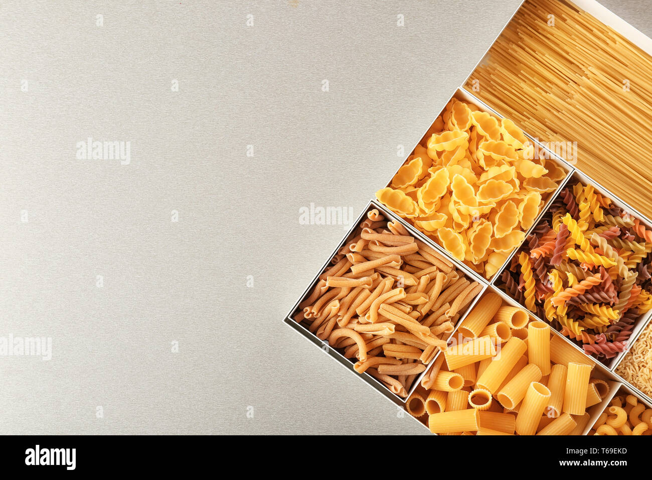 Boxes with different uncooked pasta on light background Stock Photo - Alamy