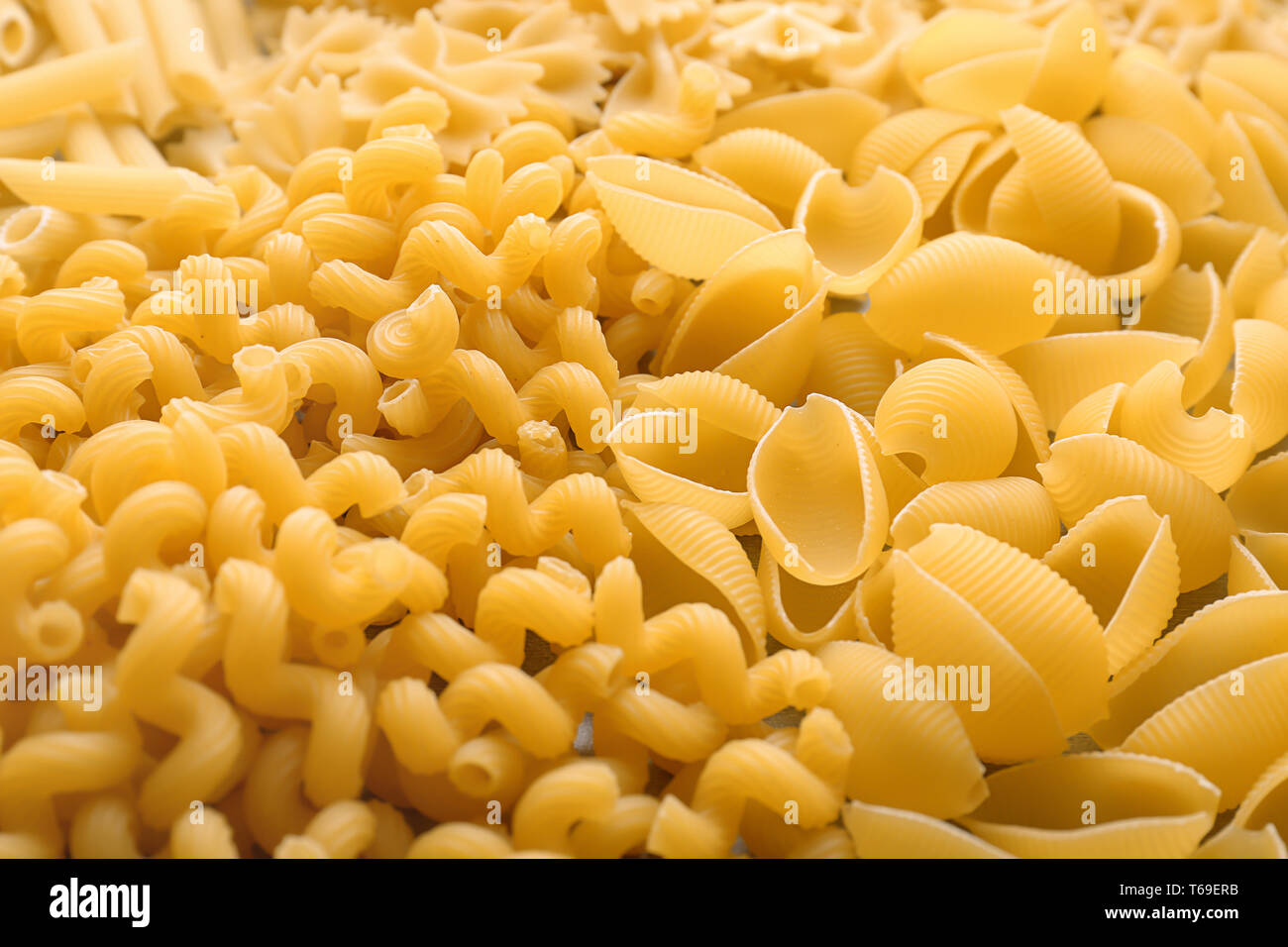 Different uncooked pasta as background, closeup Stock Photo - Alamy
