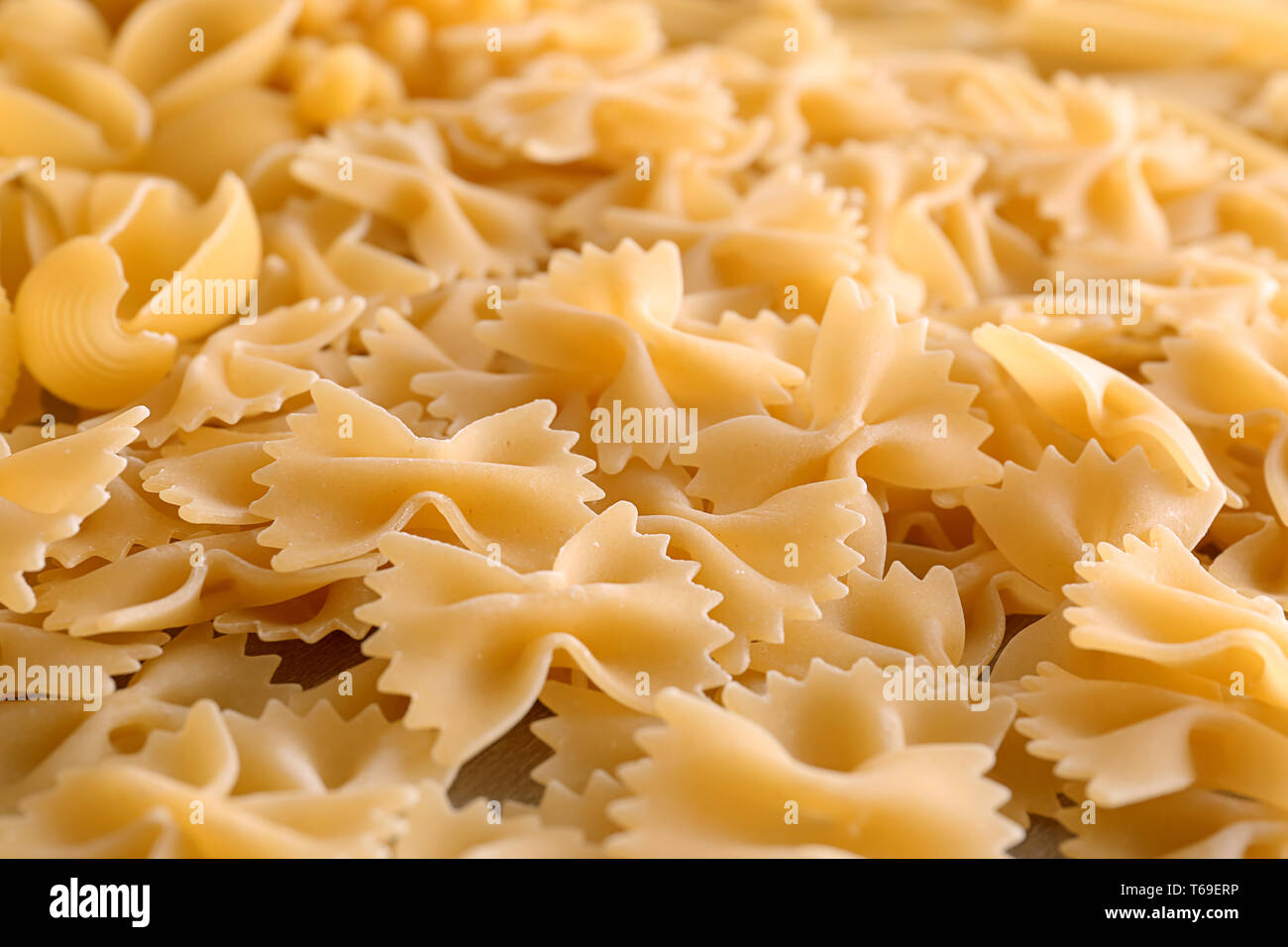 Uncooked pasta as background, closeup Stock Photo - Alamy