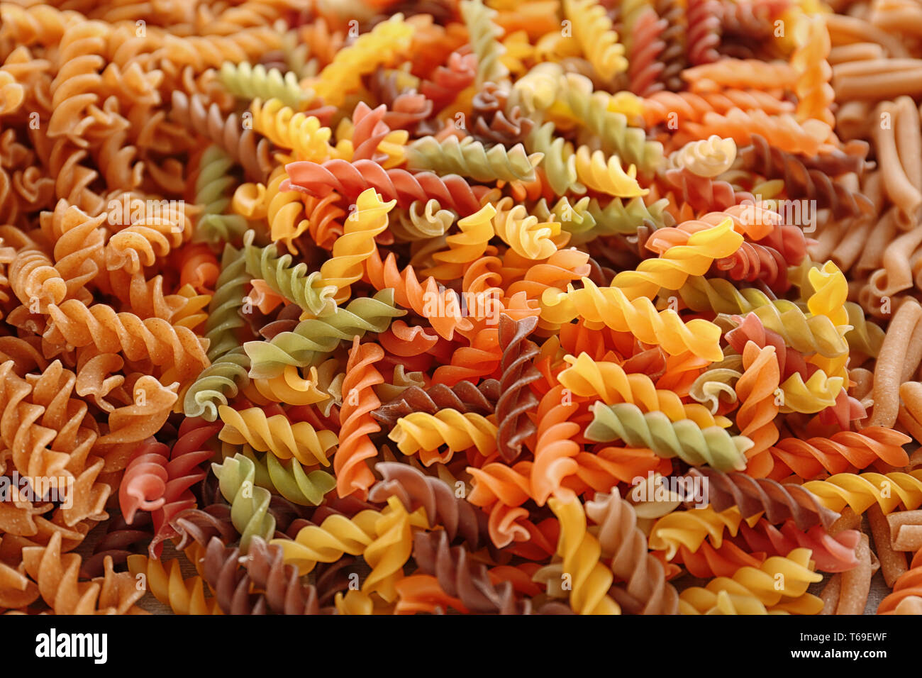 Uncooked pasta as background, closeup Stock Photo - Alamy