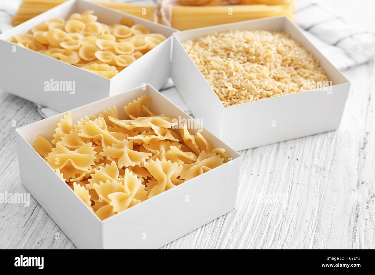 Boxes with different uncooked pasta on table Stock Photo - Alamy