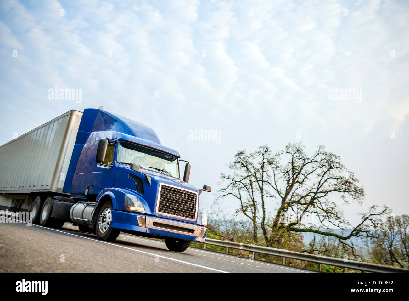 Bright blue modern comfortable big rig bonnet freight transportation ...