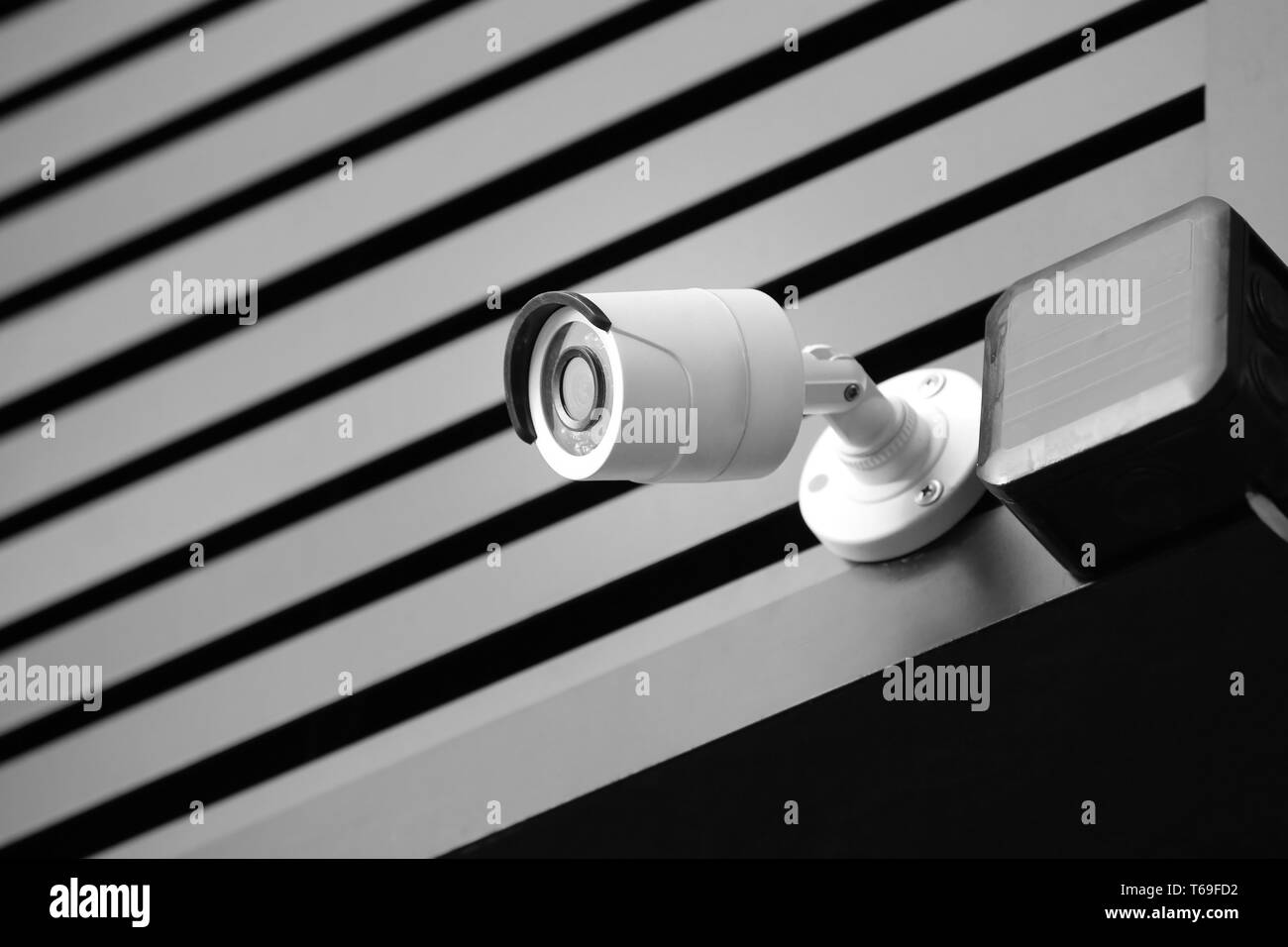 Modern CCTV camera on wall of building outdoors Stock Photo - Alamy