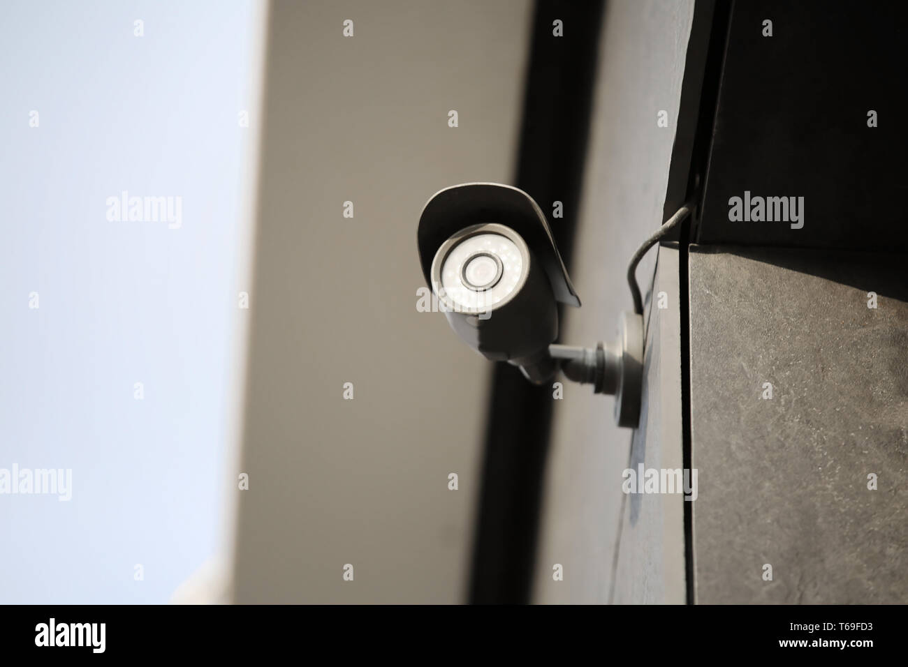 Modern CCTV camera on wall of building outdoors Stock Photo - Alamy
