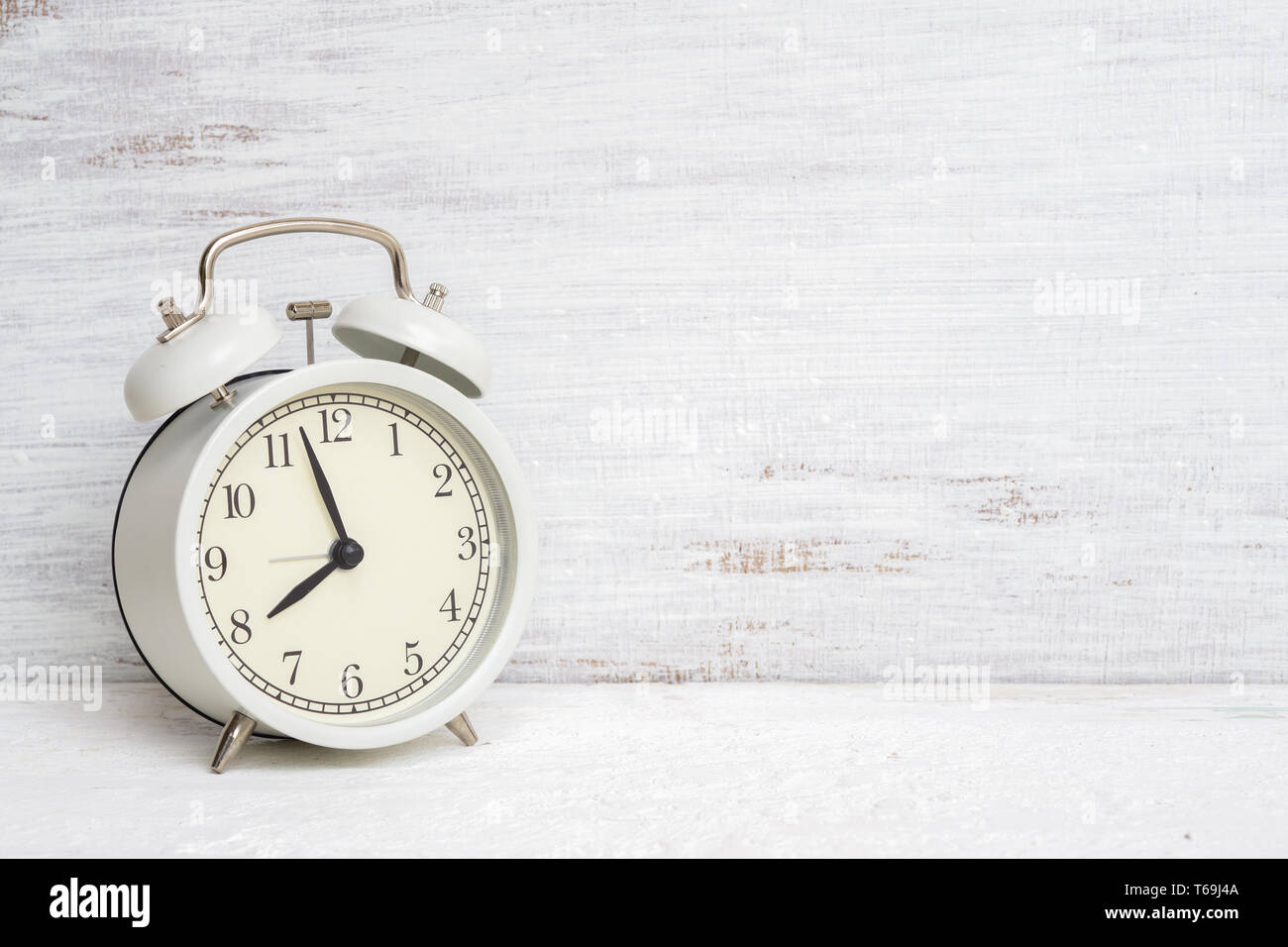 Vintage classic white alarm clock on white grunge background with free ...