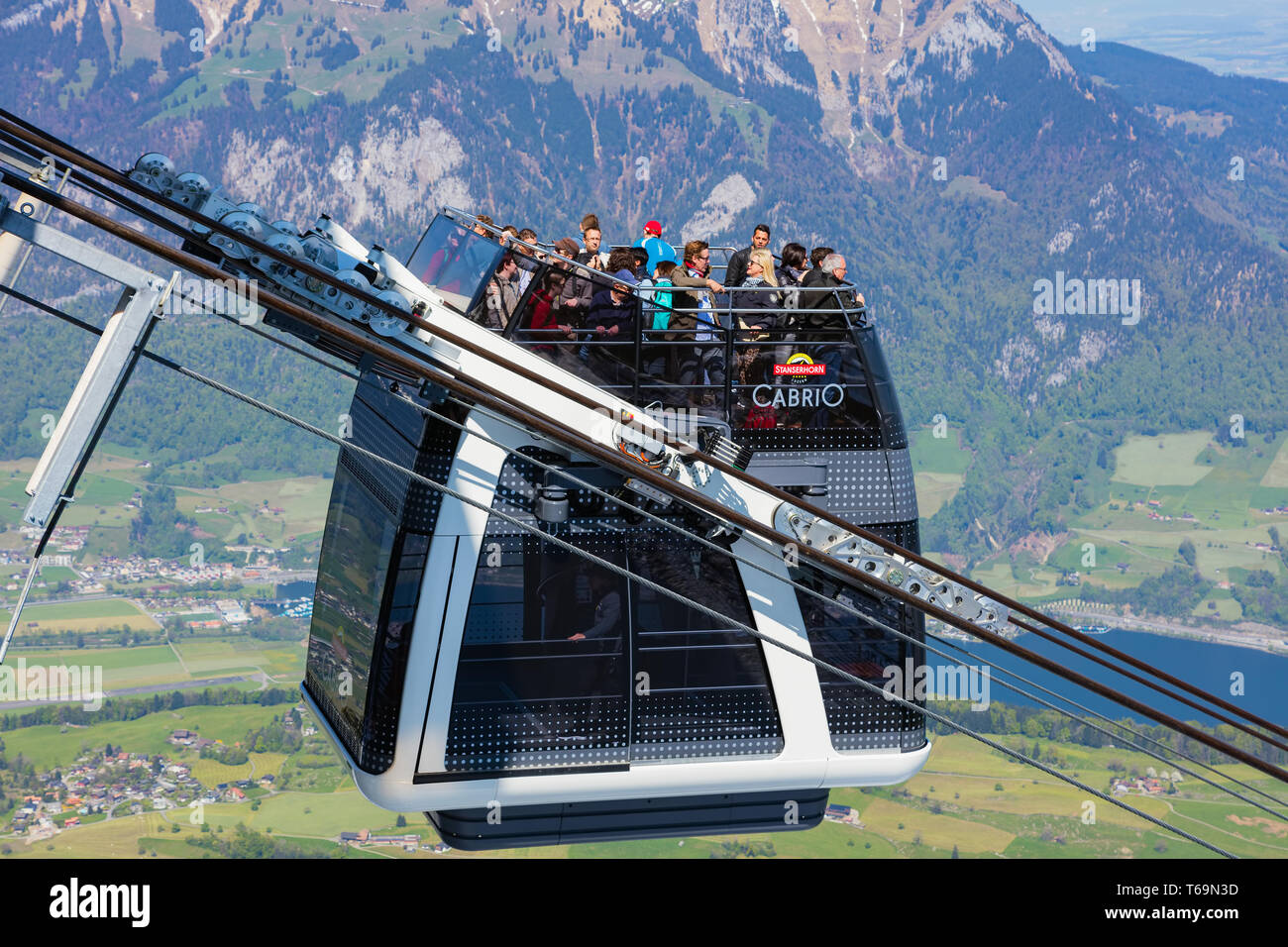 Mt. Stanserhorn, Switzerland - May 7, 2016: people in a gondola of the ...