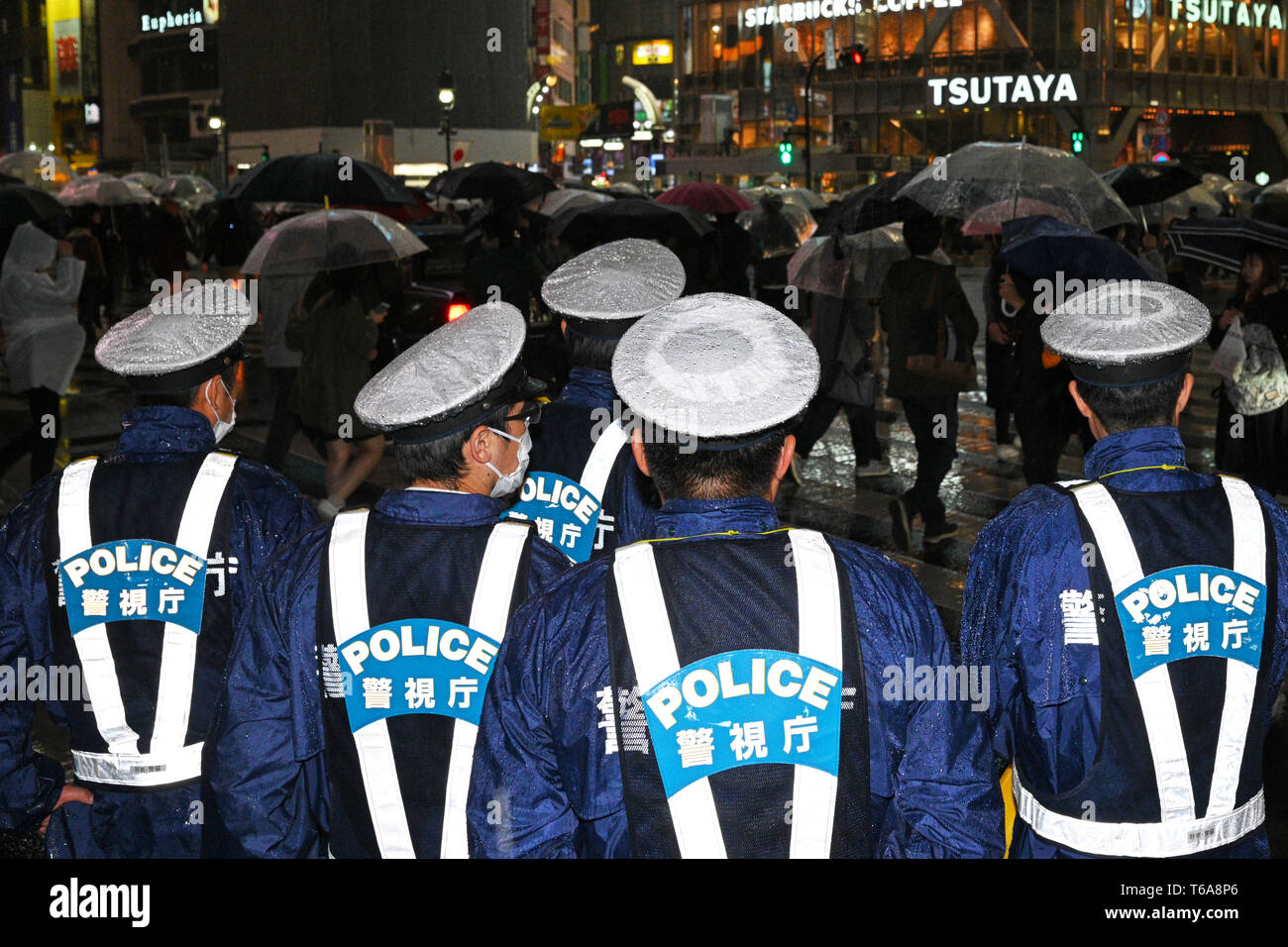 Police officers are deployed as people gather to celebrate the change ...