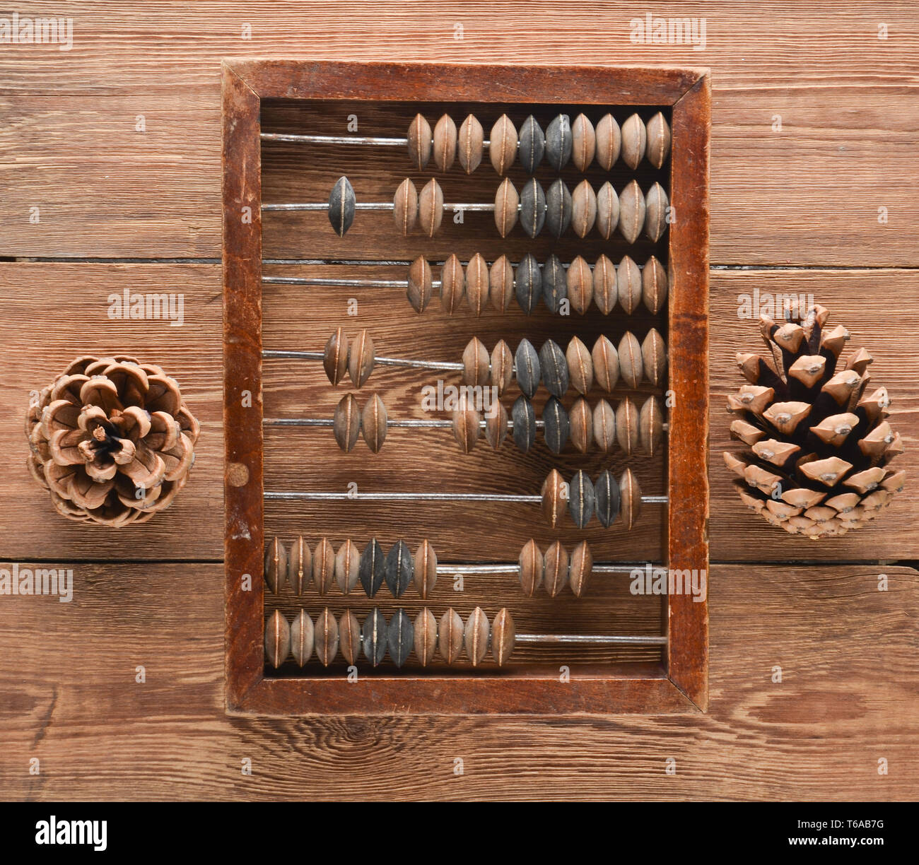Vintage scores and cones on wooden table. Top view. Ancient methods of ...