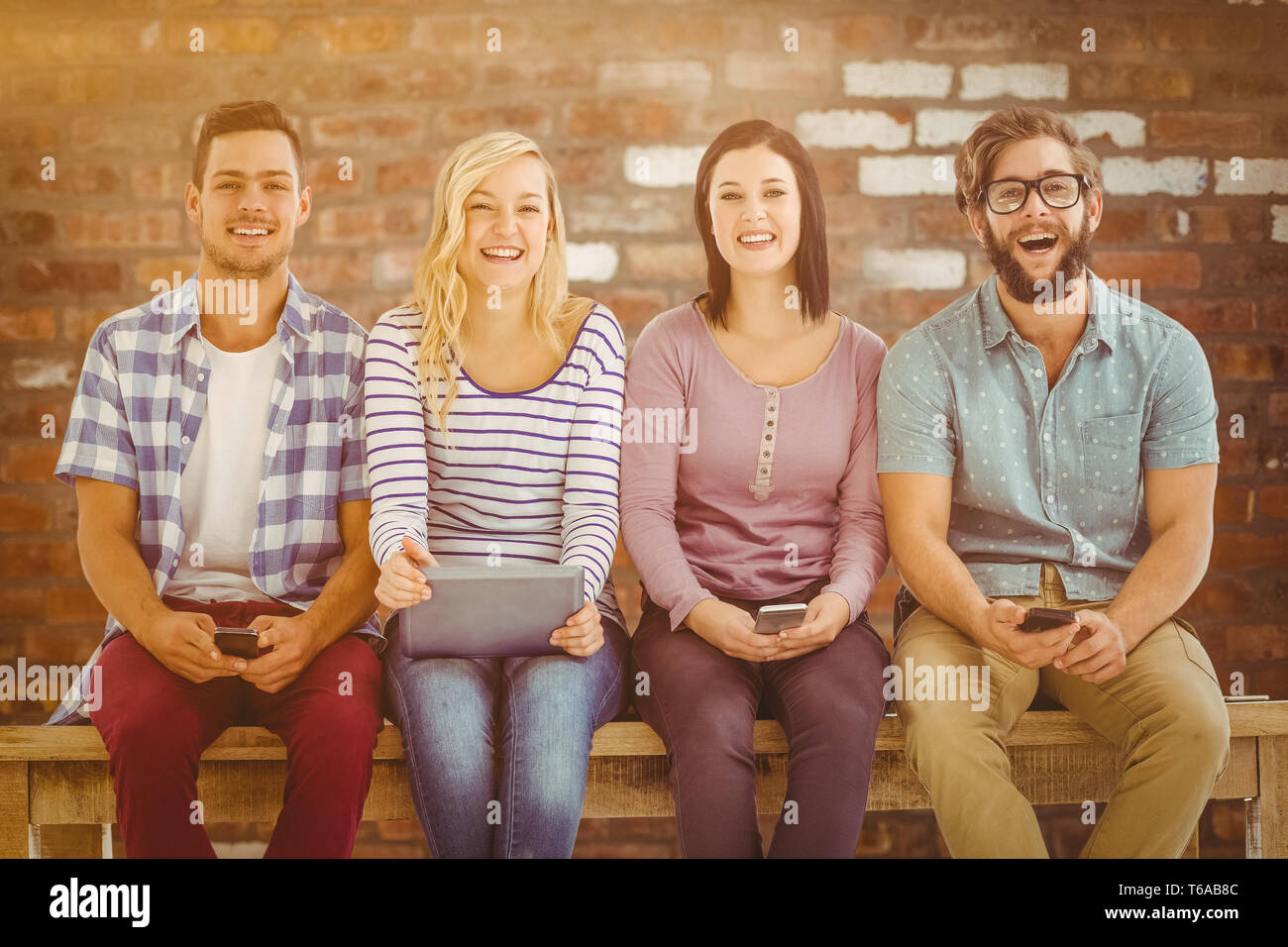 Composite image of portrait of smiling business people holding ...