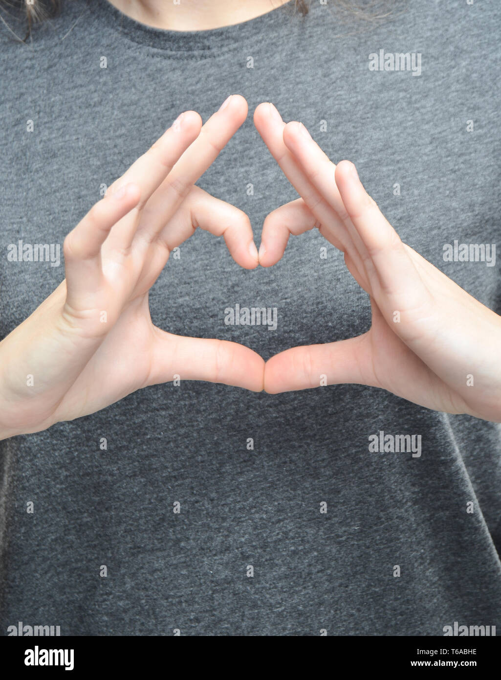 A symbol of the heart with the fingers of a female hand Stock Photo - Alamy