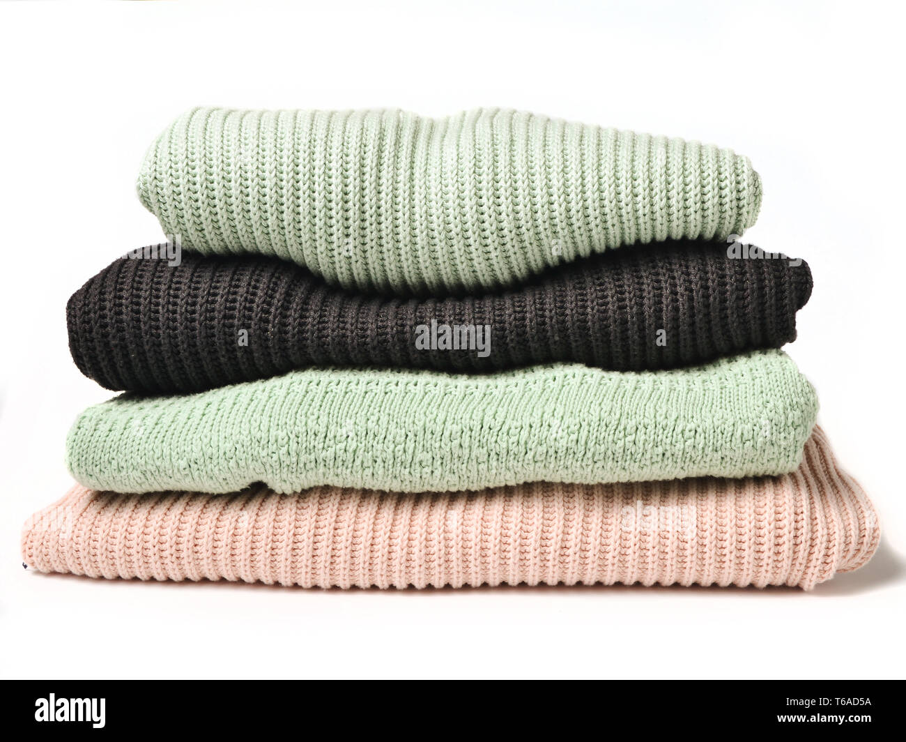 A stack of sweaters isolated on white background Stock Photo - Alamy