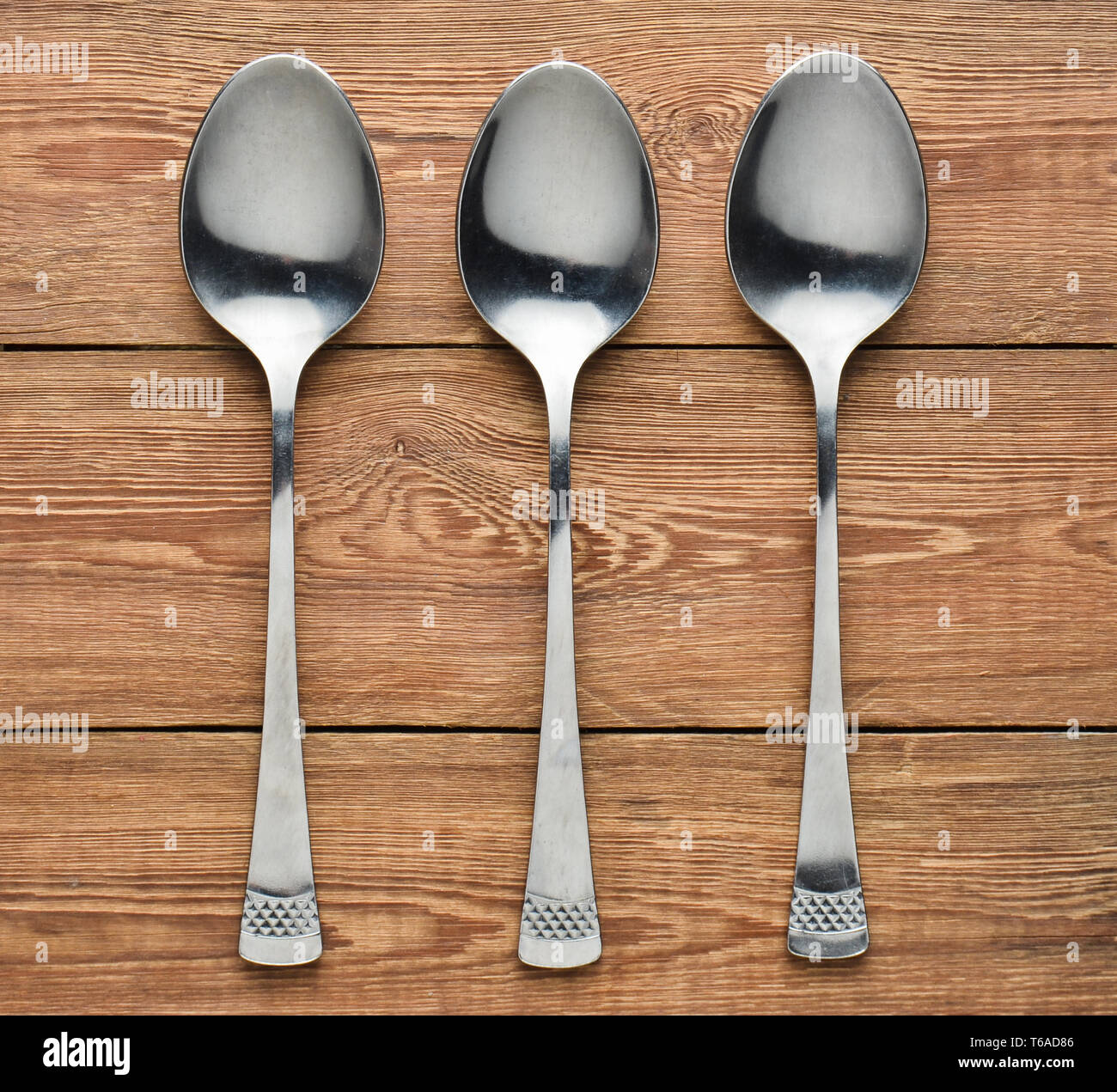 Antique spoons on a rustic wood background hi-res stock photography and ...