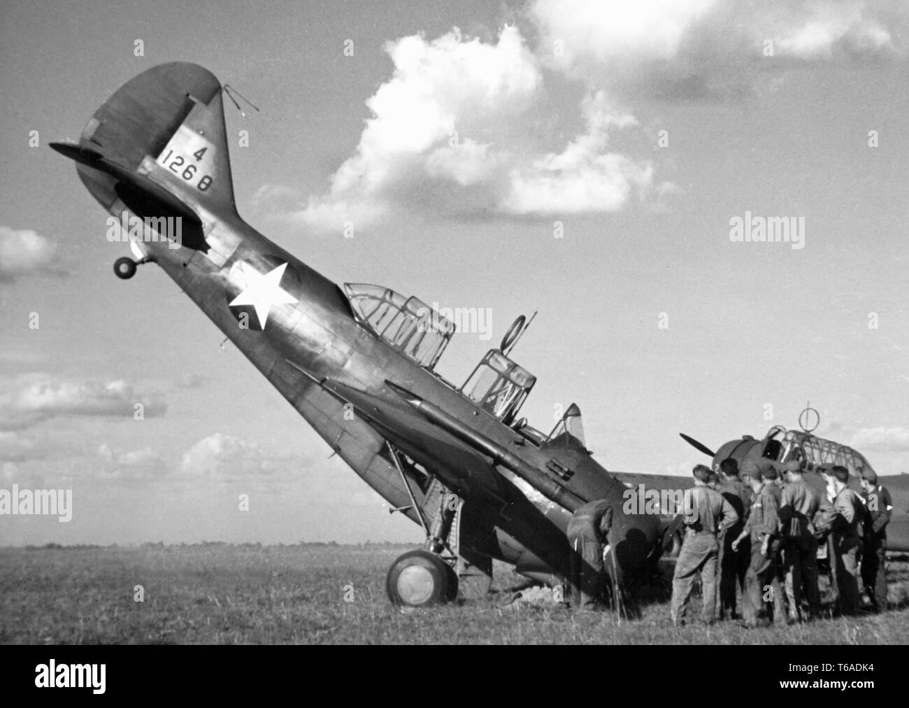 US servicemen, inspect a crashed Army airplane in the South Pacific ...