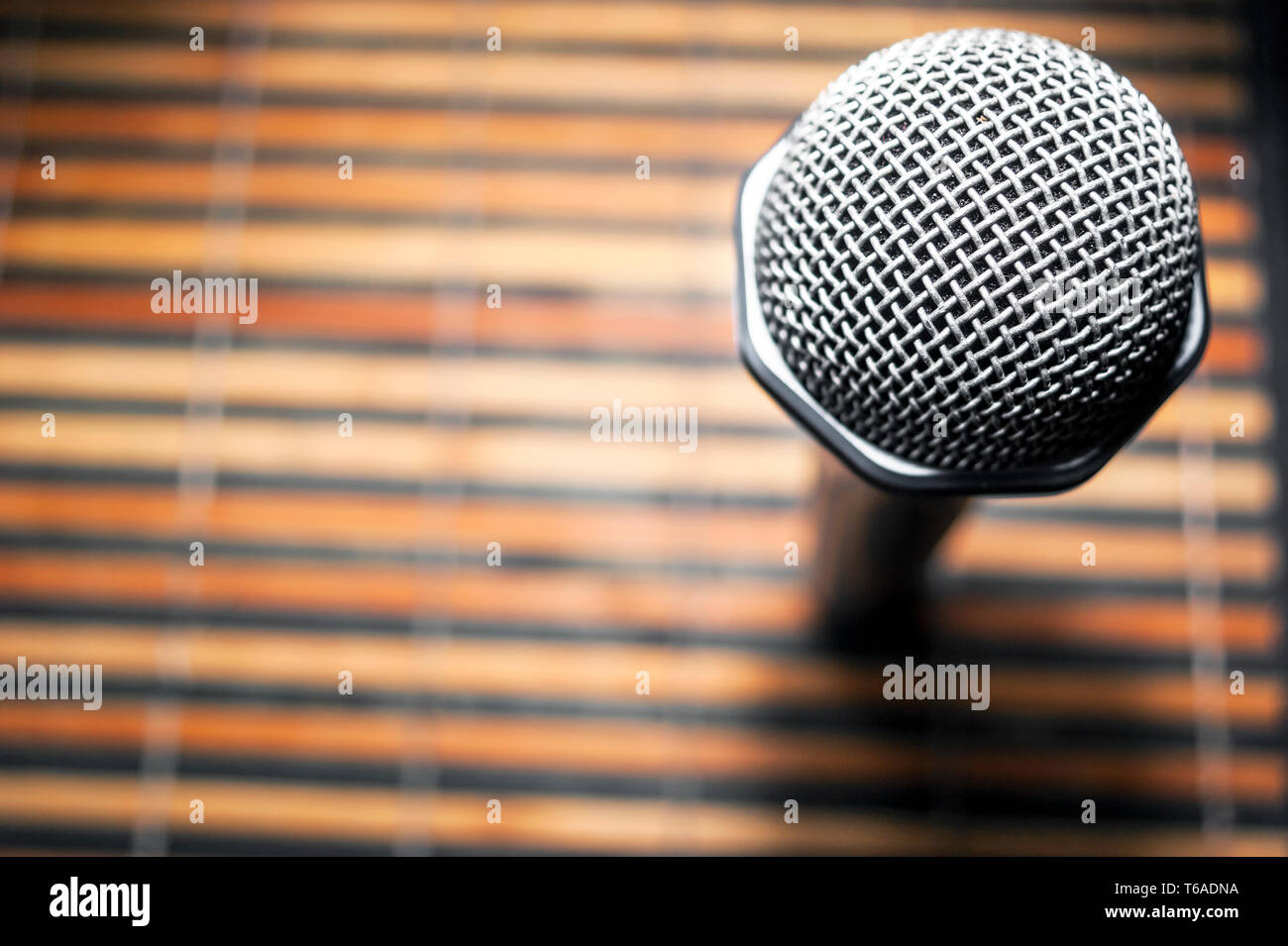 Top-Down View of A Microphone Head and Silver Grille on A Striped ...