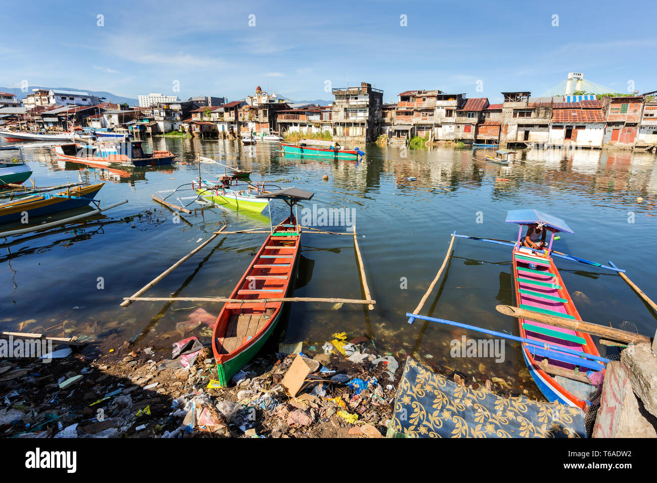 poor houses by the river in shantytown Stock Photo - Alamy