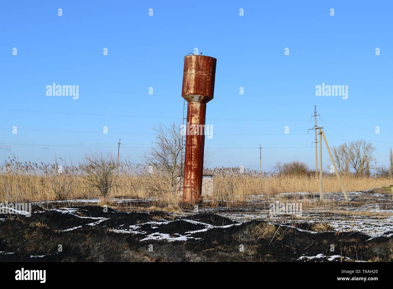 The old rusty water tower tilted Stock Photo - Alamy