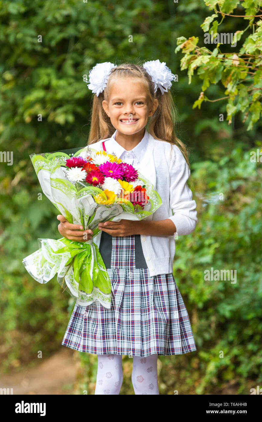 First grader with a bouquet of flowers smiling happily Stock Photo - Alamy