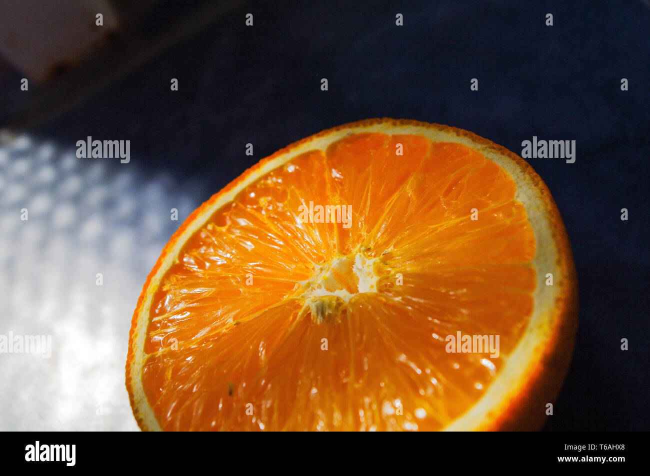 fresh orange halved in closeup, oranges cut in half Stock Photo - Alamy