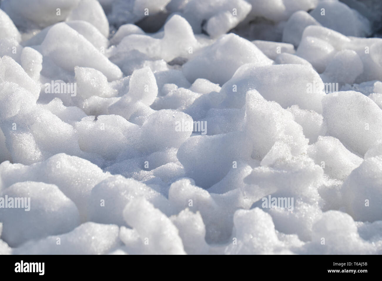 Lumps of snow and ice frazil on the surface of the freezing river water ...