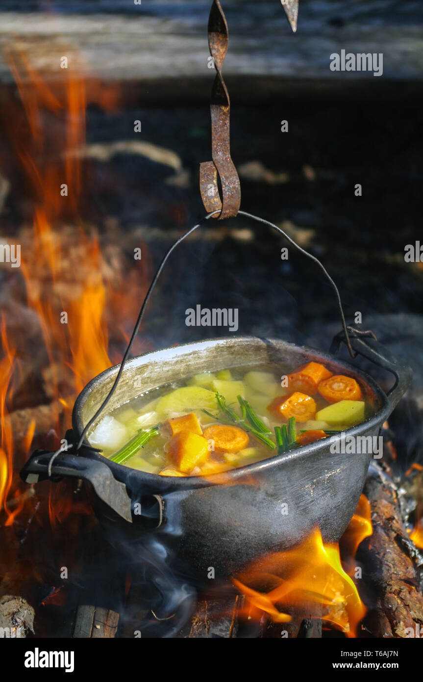vegetables prepared in a pot over fire on the nature Stock Photo - Alamy