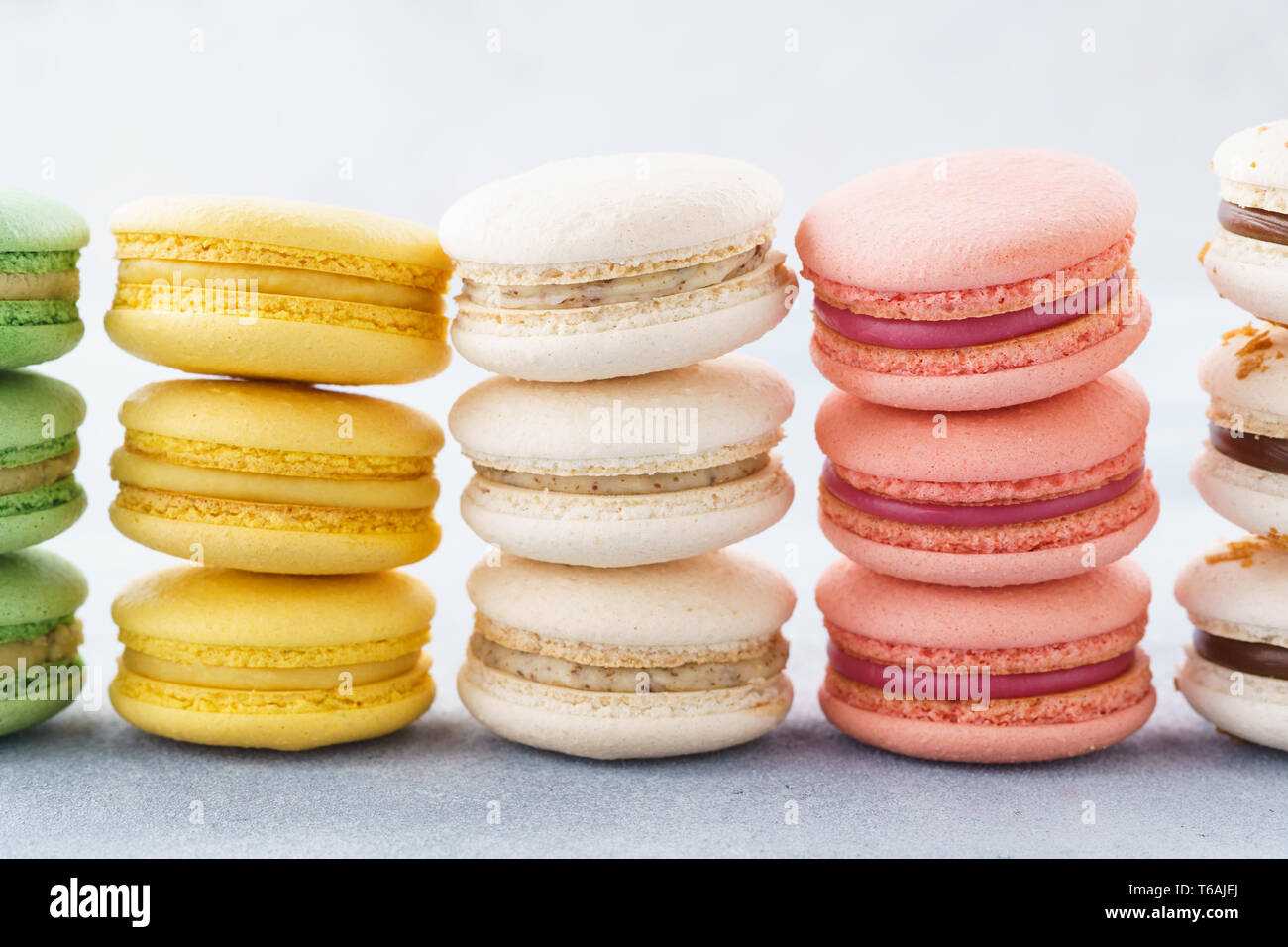 Stacks of colorful macarons with various fillings in a row Stock Photo ...