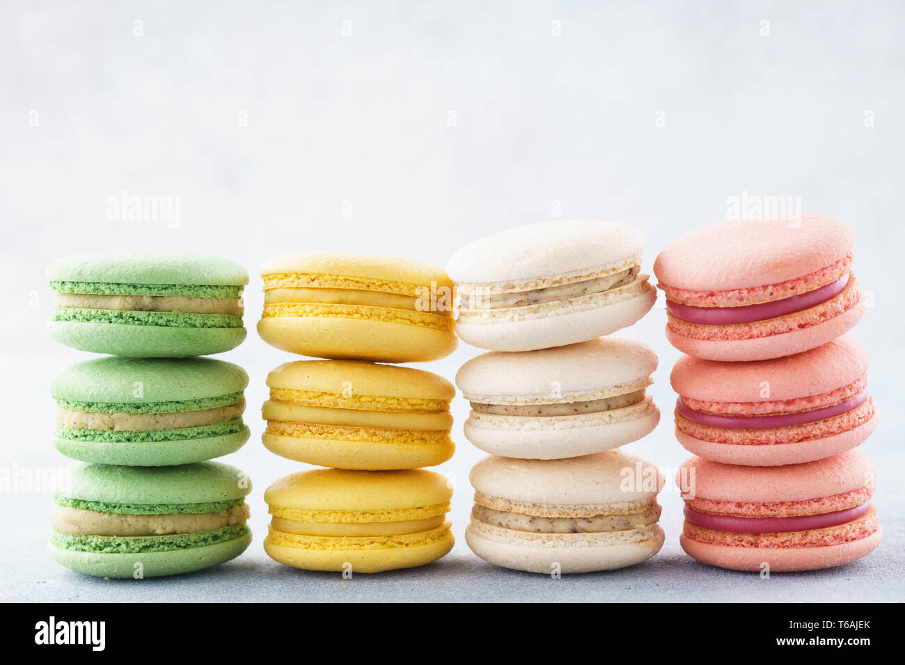 Stacks of various colorful macarons in a row. Creative design layout ...