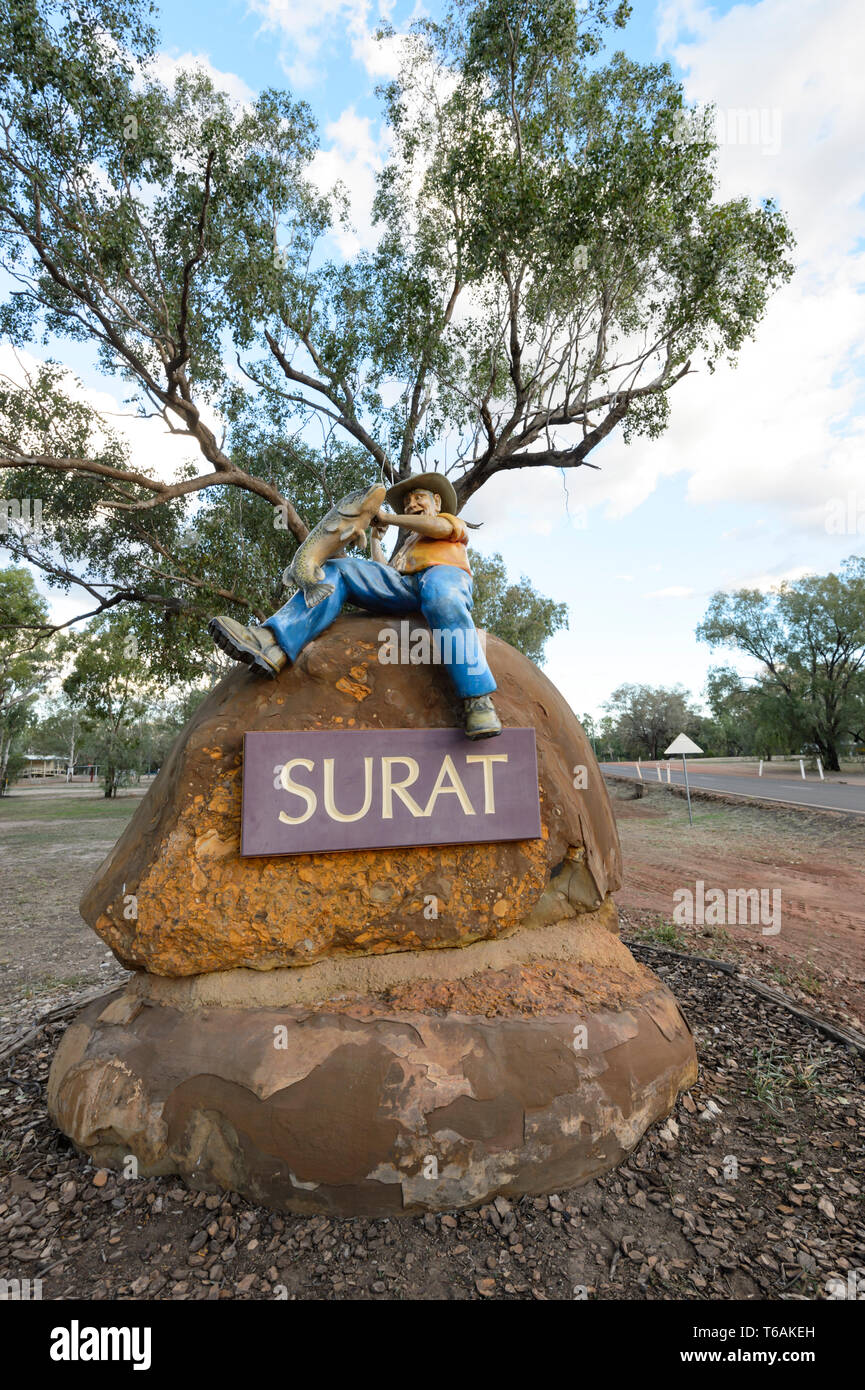 Statue of a fisherman on a boulder at the entrance of the small rural ...