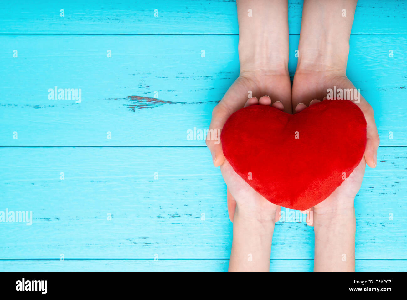 kids hands with a heart and supported by mothers hands Stock Photo - Alamy