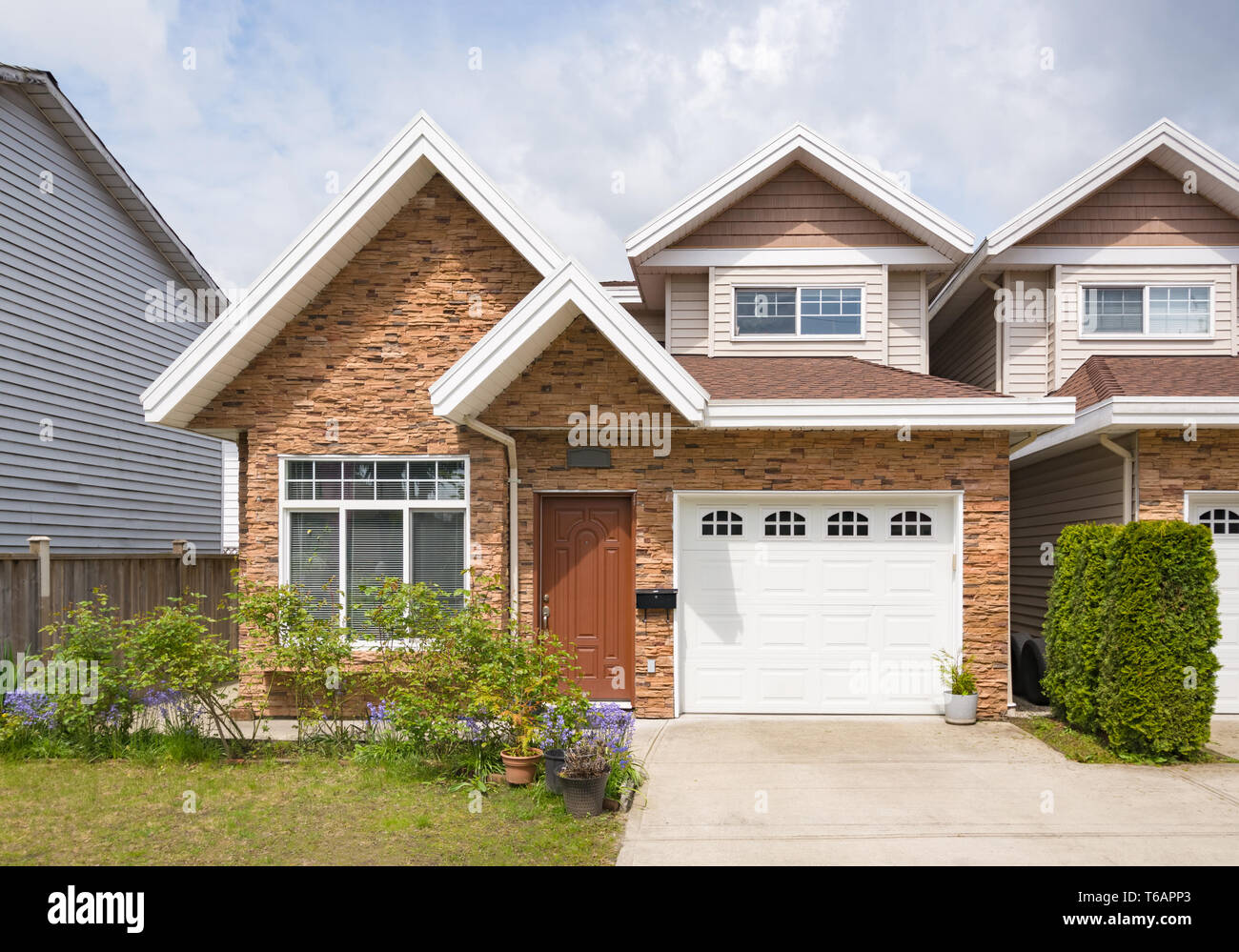 Half of residential duplex building with concrete driveway Stock Photo ...