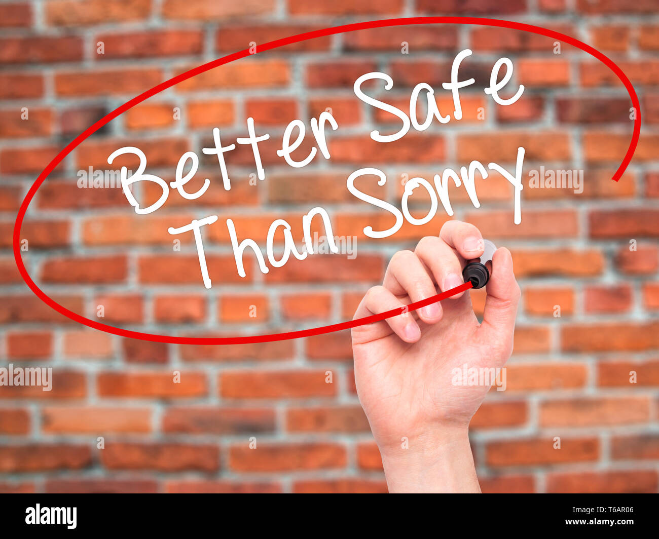 Man Hand writing Better Safe Than Sorry with black marker on visual ...