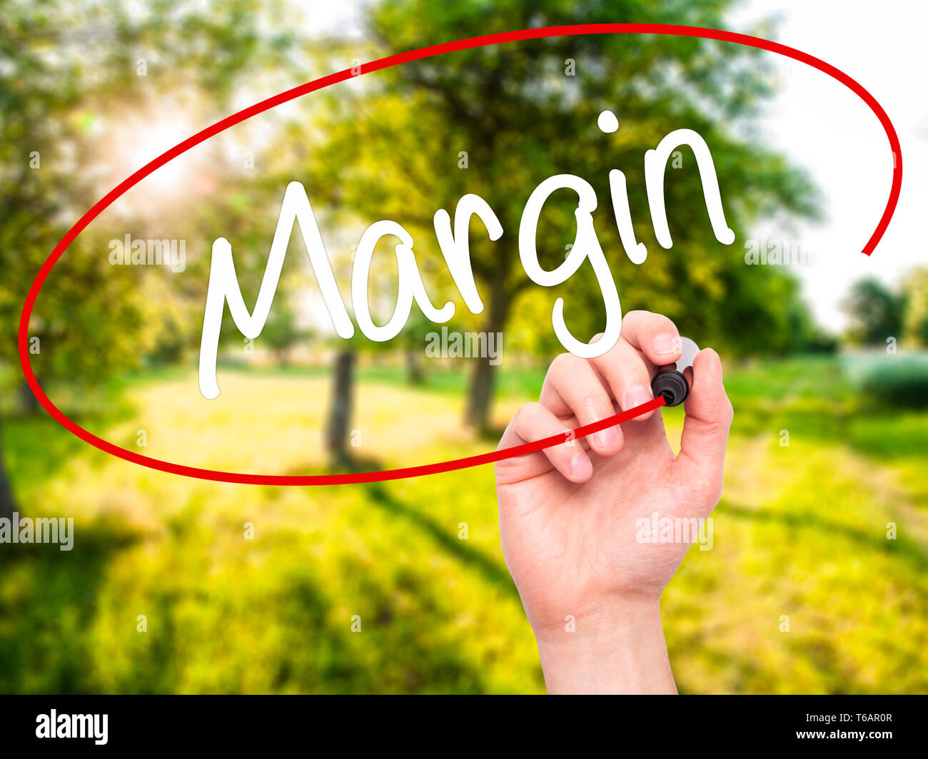 Man Hand writing Margin with black marker on visual screen Stock Photo ...