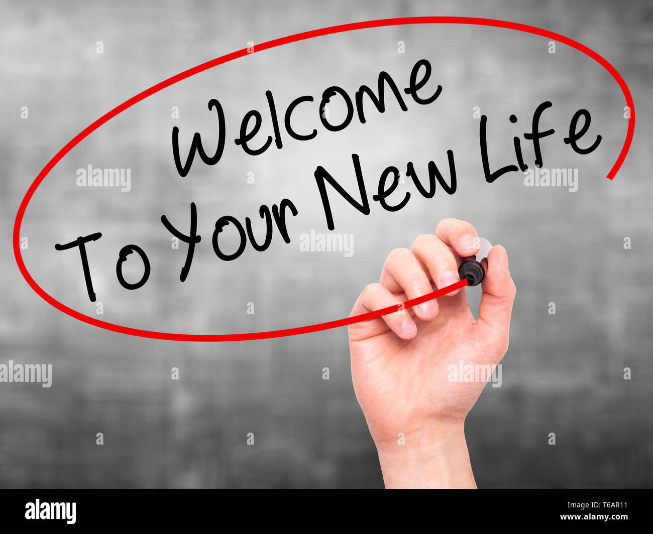 Man Hand writing Welcome To Your New Life with black marker on visual ...