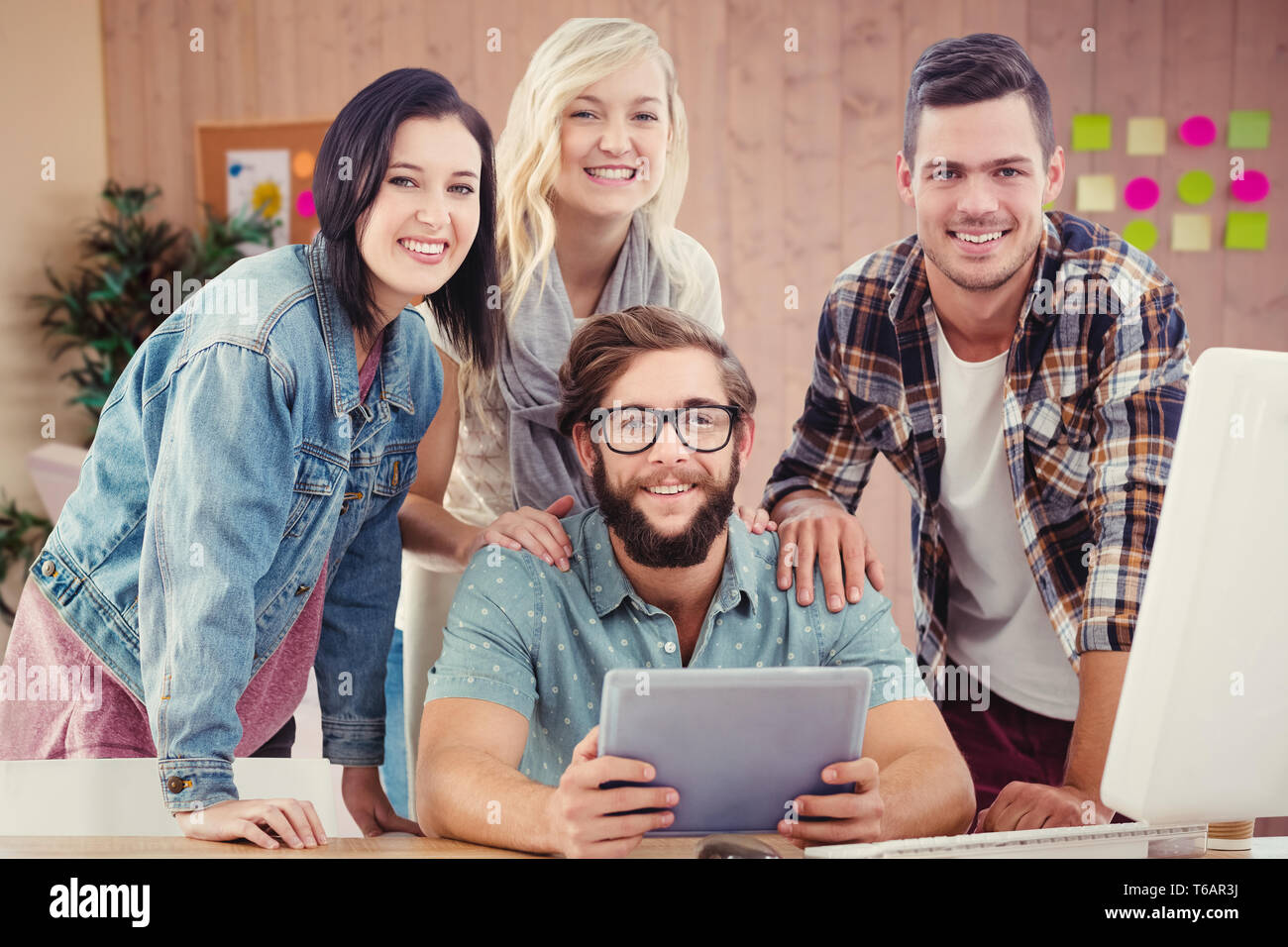 Composite image of portrait of smiling business people using digital ...