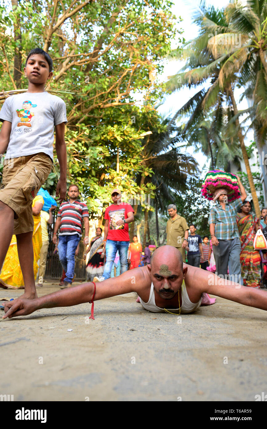 Hindu devotees prostrating their way to Juhu beach for the Chhath Pujia ...