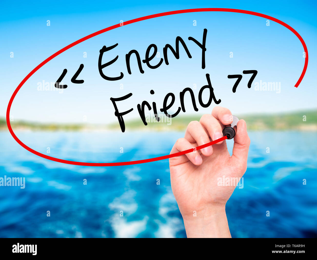 Man Hand writing Enemy - Friend with black marker on visual screen ...