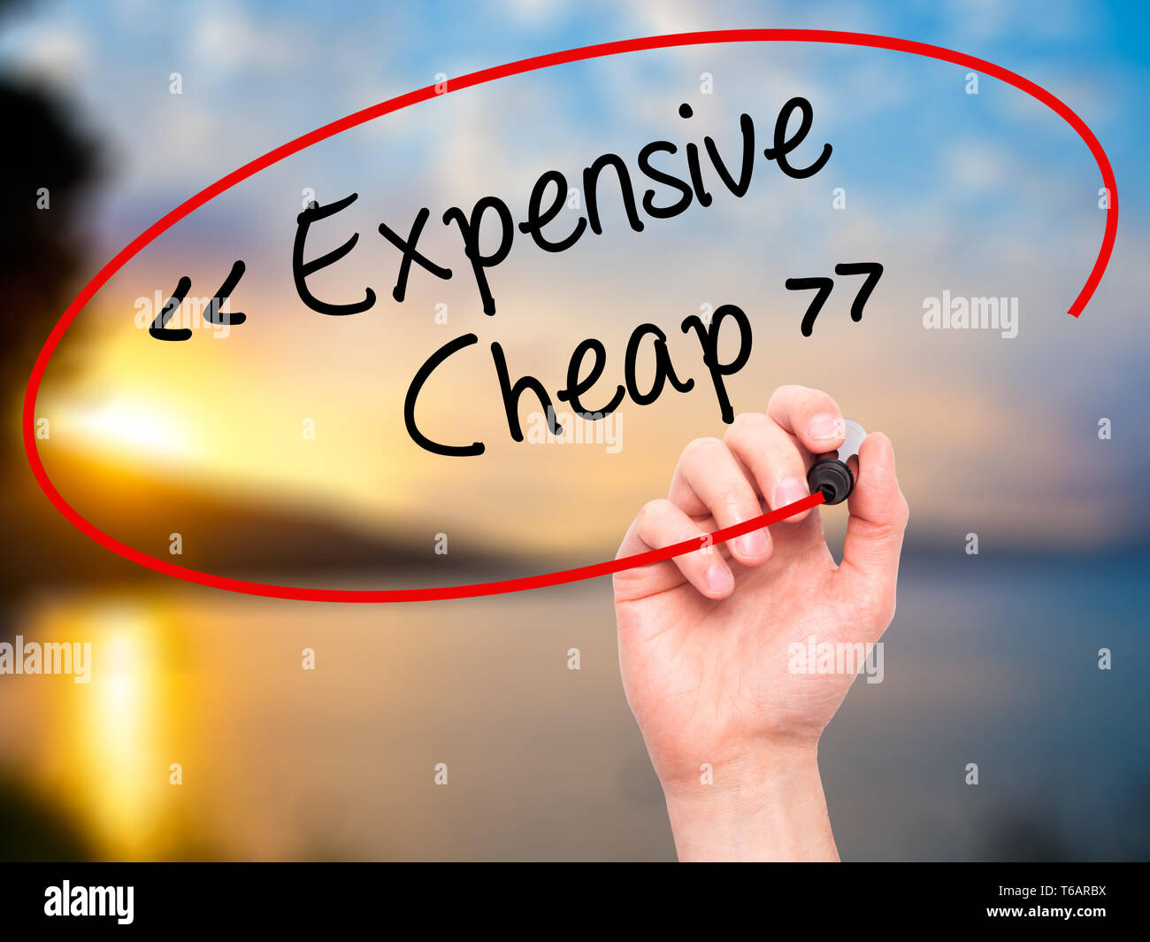 Man Hand writing Expensive - Cheap with black marker on visual screen ...