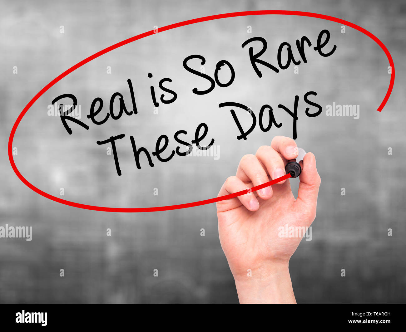 Man Hand writing Real is So Rare These Days with black marker on visual ...