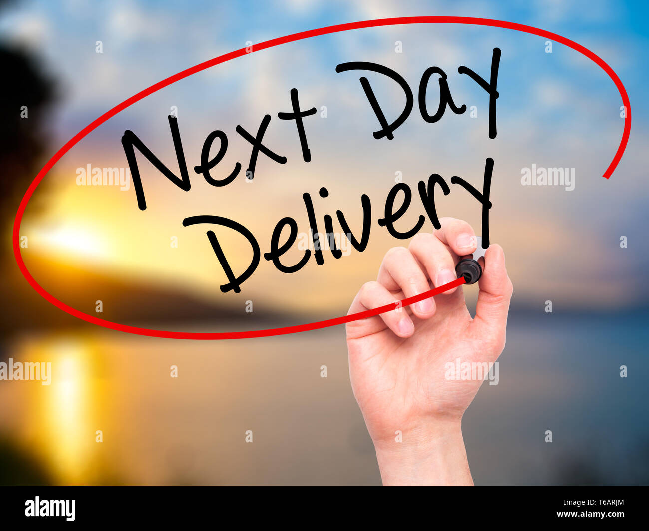 Man Hand writing Next Day Delivery with black marker on visual screen ...