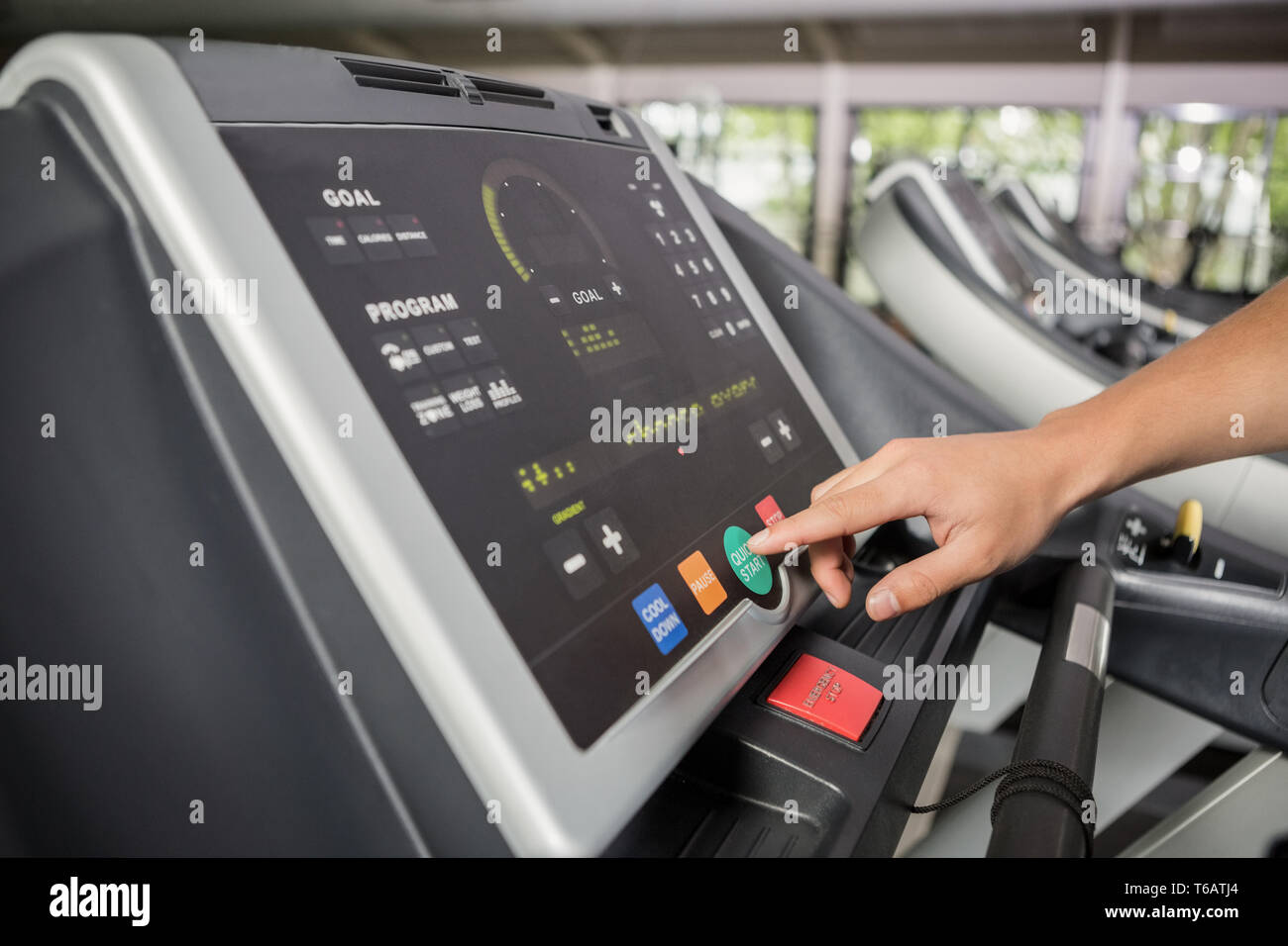 Hand pressing a button on the console display of a treadmill Stock ...