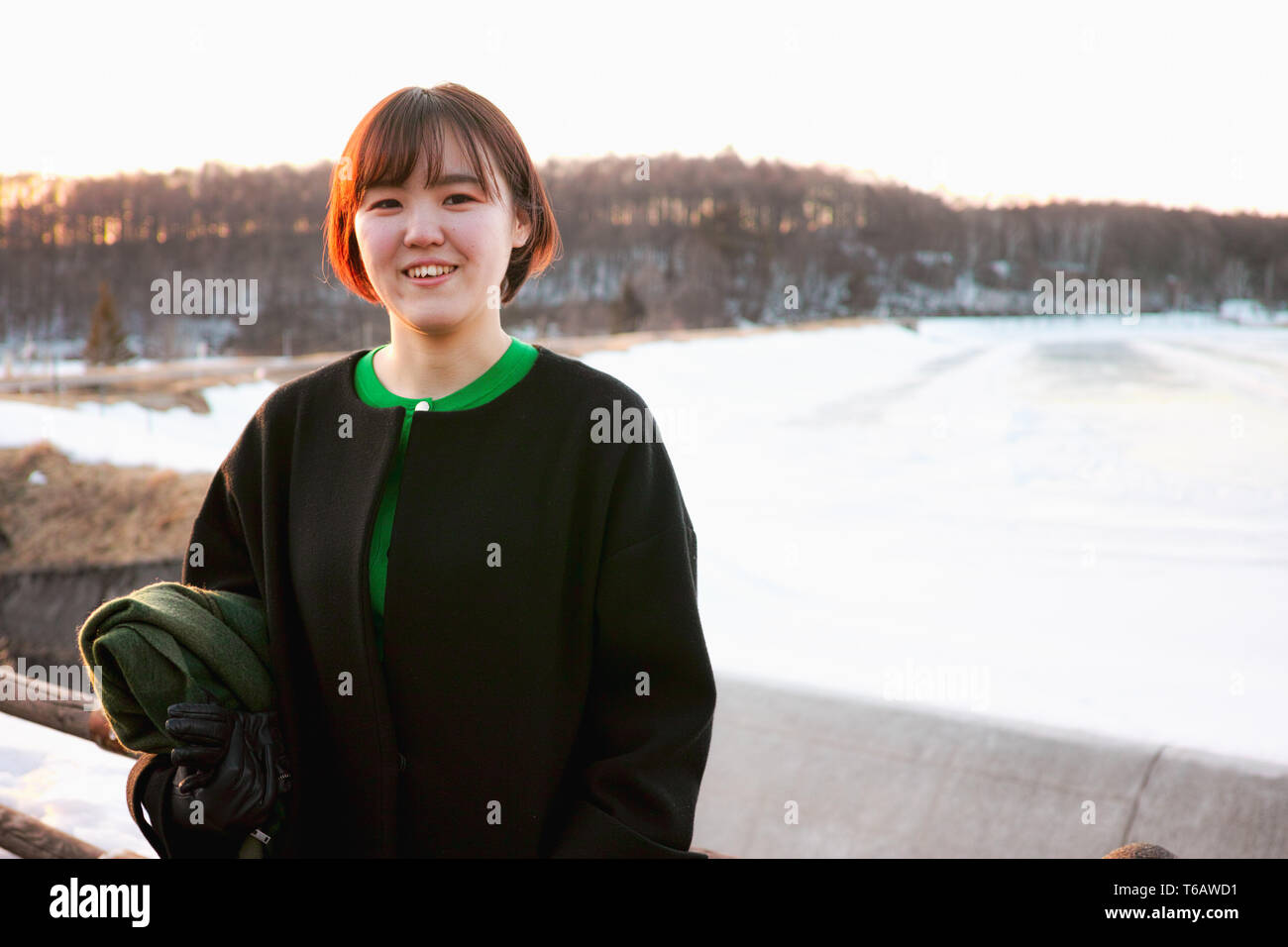 A beautiful young woman smiling into the camera, with copy space on the ...