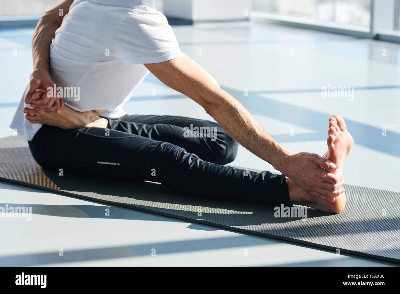 Stretching exercise on mat Stock Photo - Alamy