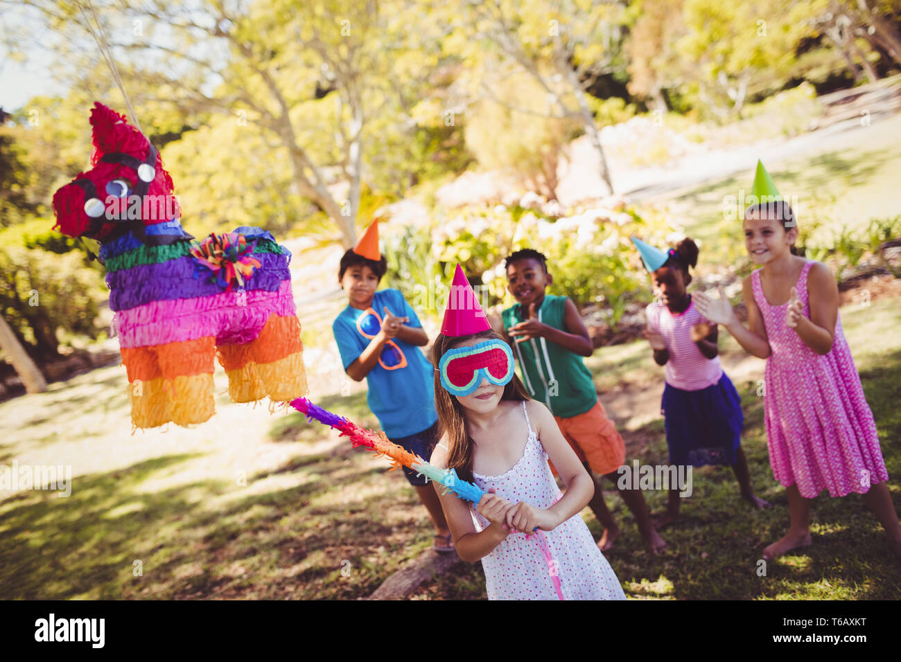 Little girl is going to broke the pinata for their birthday Stock Photo ...