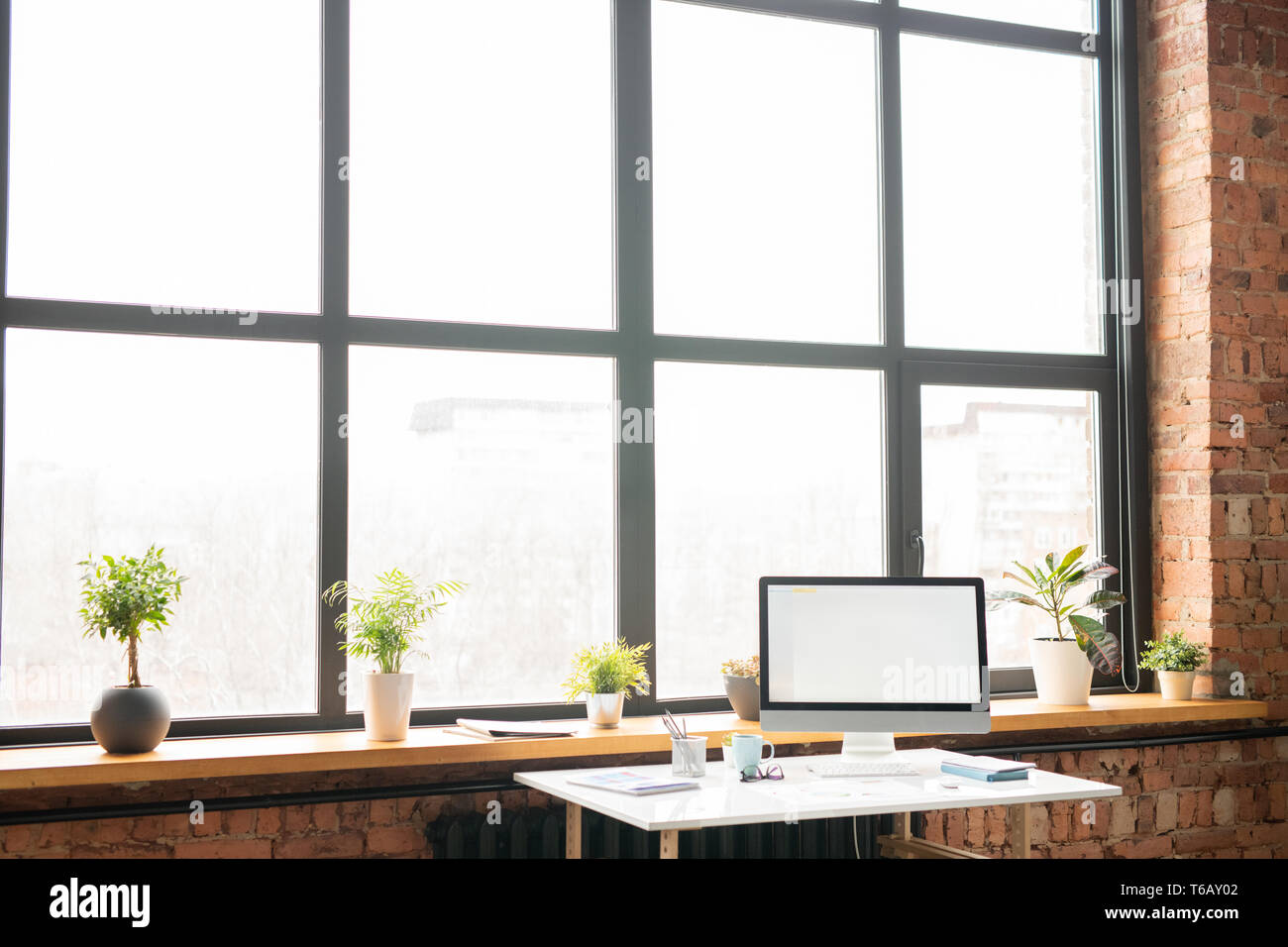 Workplace by office window Stock Photo - Alamy