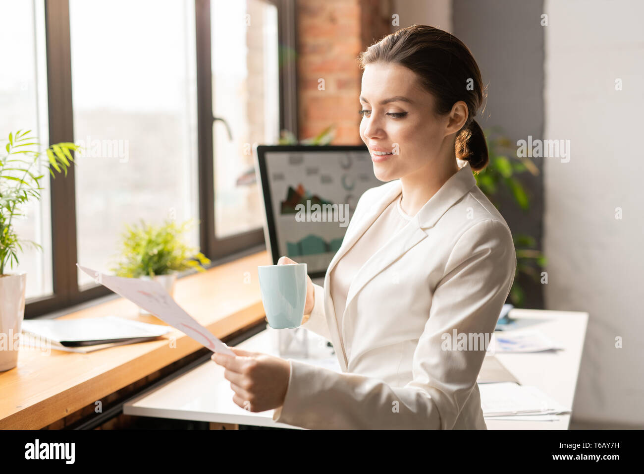Reading paper by workplace Stock Photo - Alamy