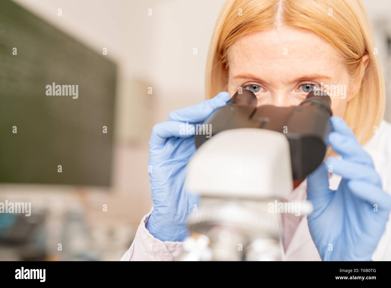 Mature clinical researcher using microscope Stock Photo - Alamy